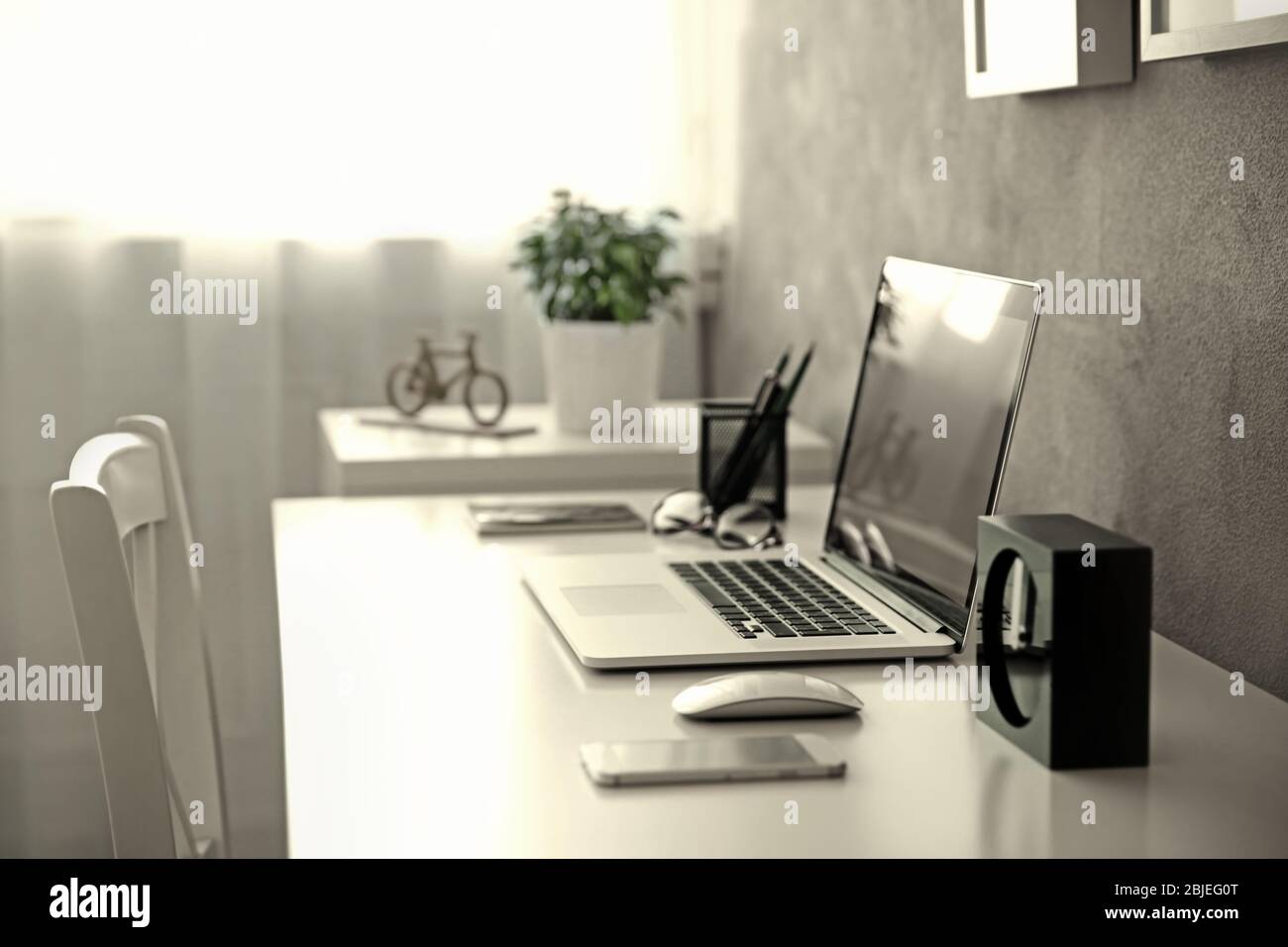 Modern workplace with laptop on table Stock Photo - Alamy