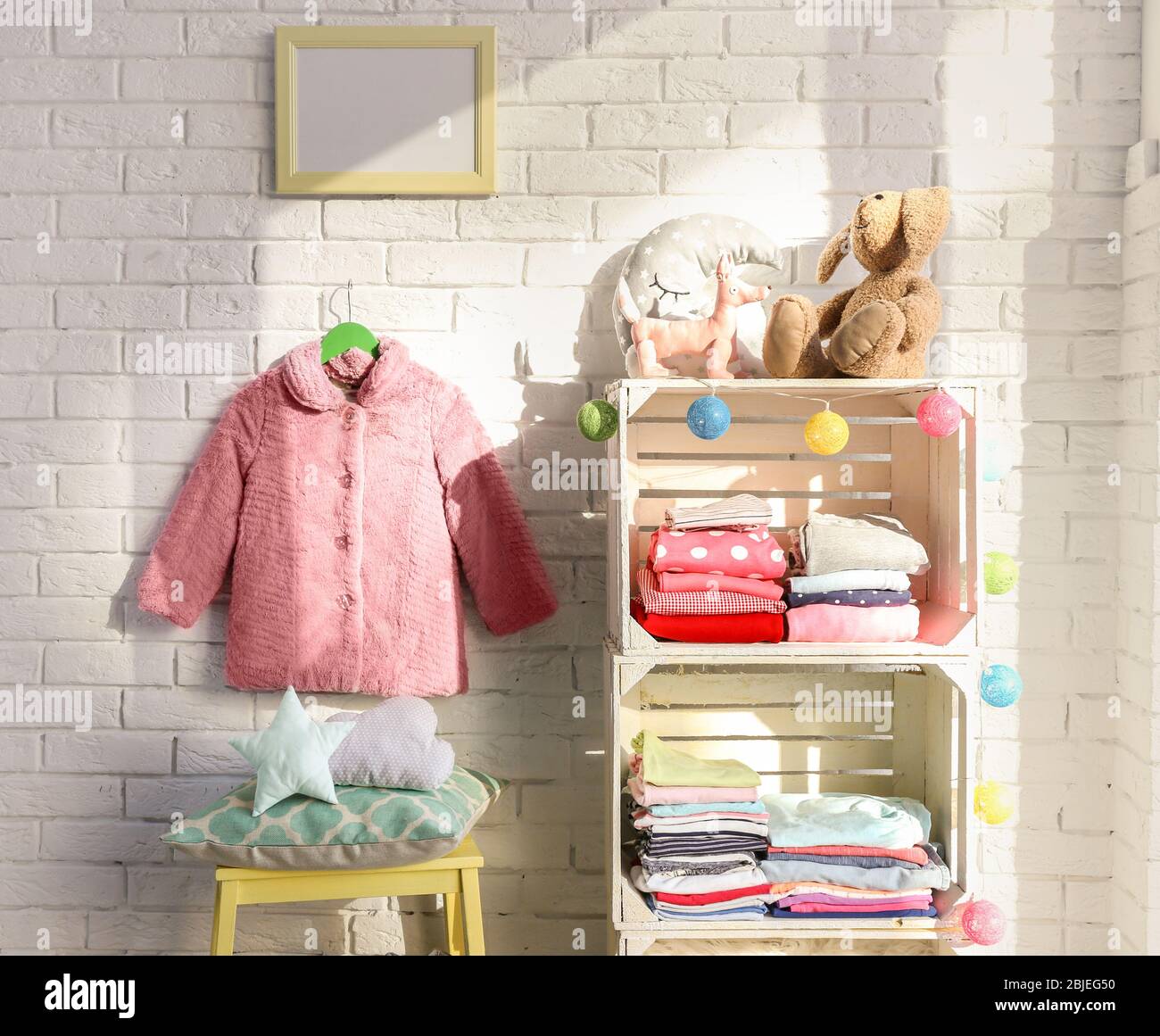 Clothes on shelf in kids room Stock Photo - Alamy