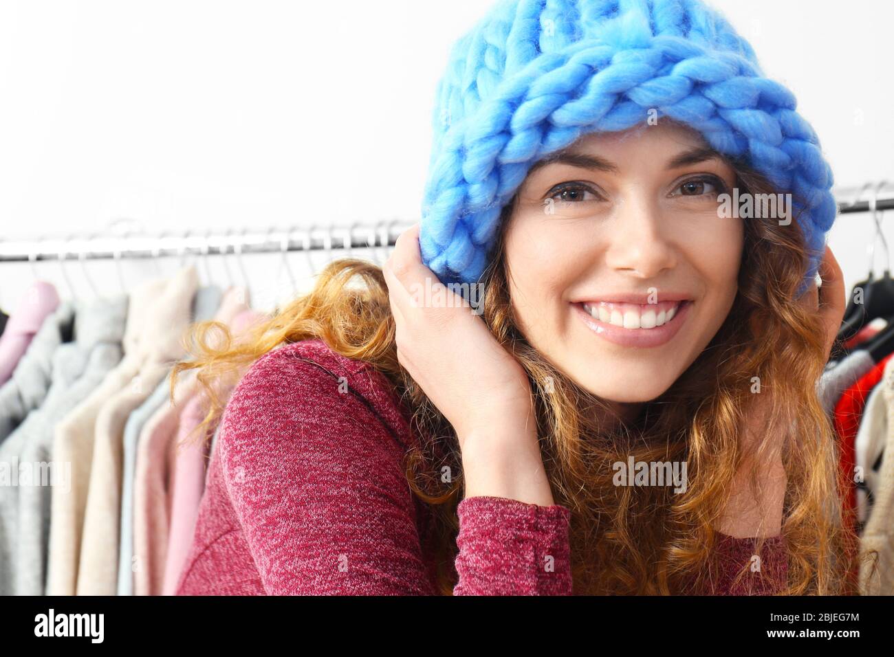 Young woman trying on cap hi-res stock photography and images - Alamy