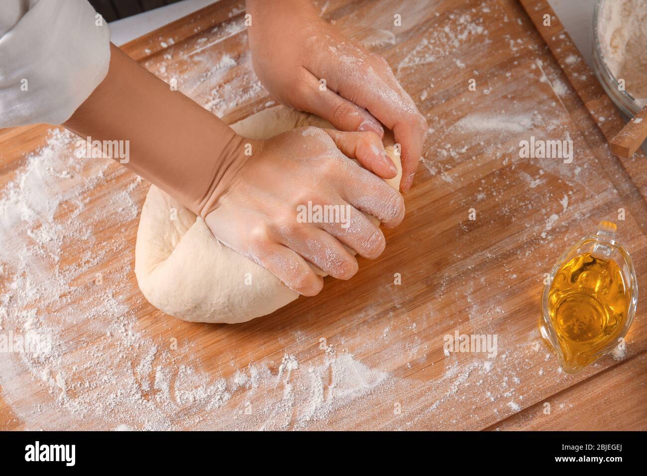 Woman making dough at kitchen Stock Photo - Alamy