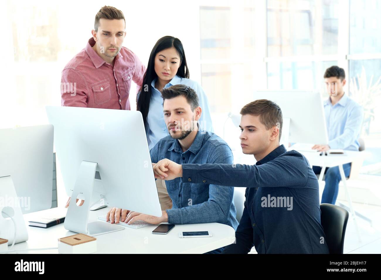 Young programmers working in office Stock Photo - Alamy