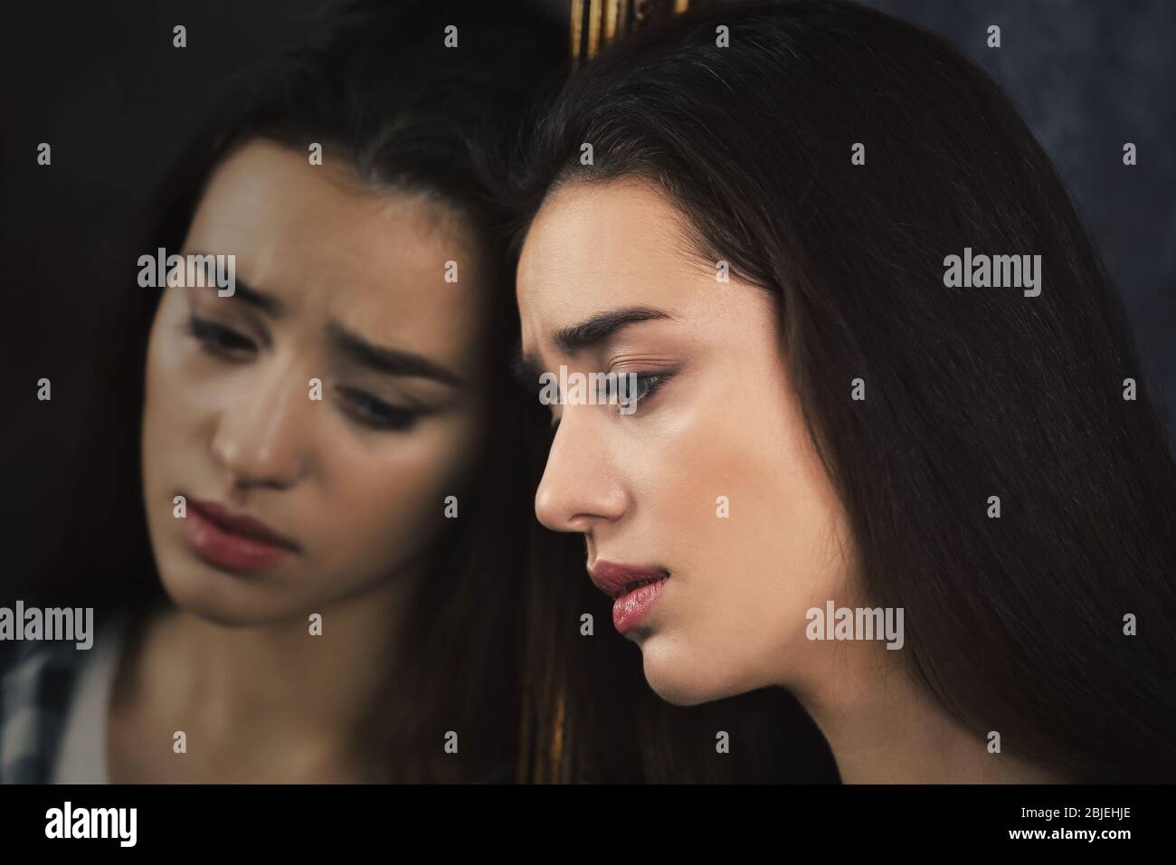 Depressed young woman and her reflection in mirror Stock Photo - Alamy