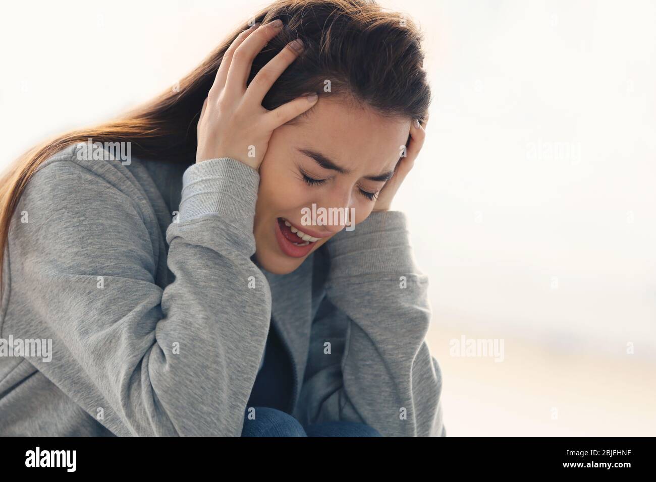Despaired young woman indoors Stock Photo - Alamy