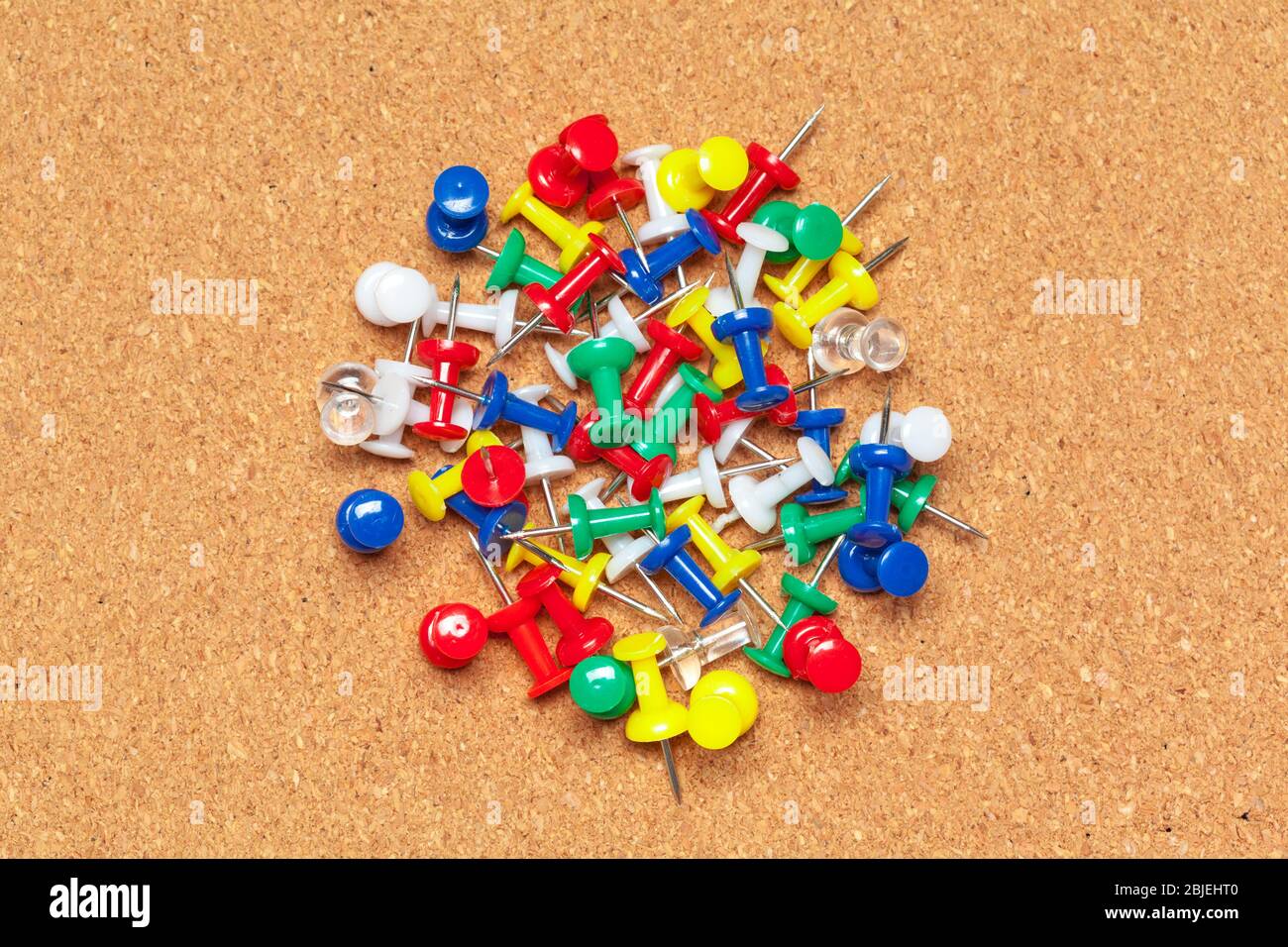 Group of thumbtacks on corkboard close up. School or business concept ...