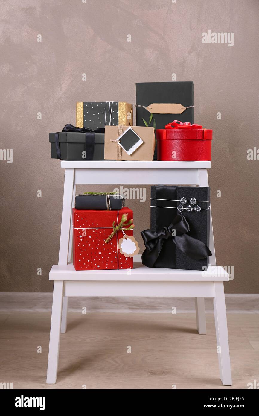 Stylish present boxes on textured wall background Stock Photo - Alamy