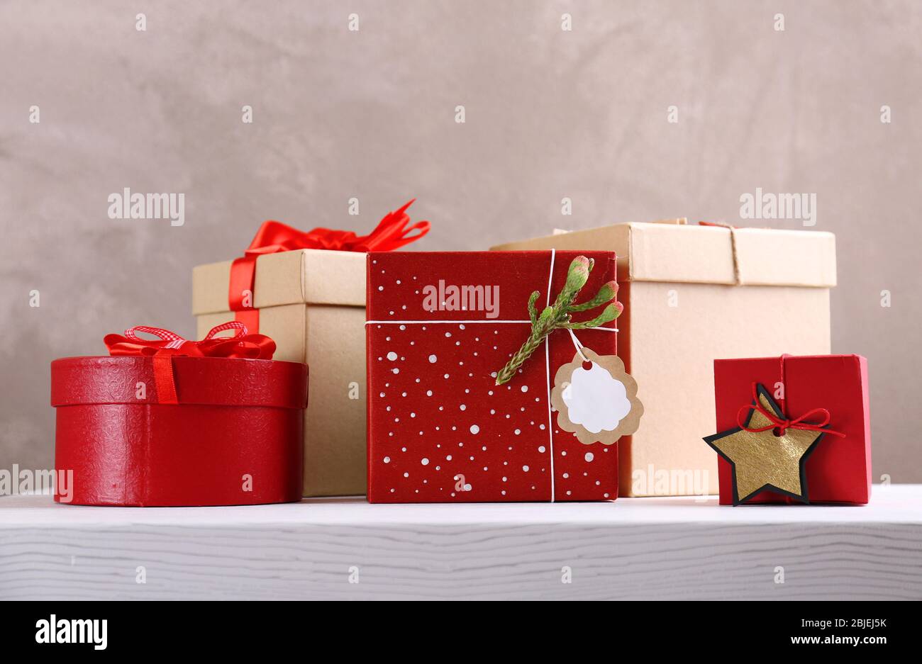 Stylish present boxes on textured wall background Stock Photo - Alamy