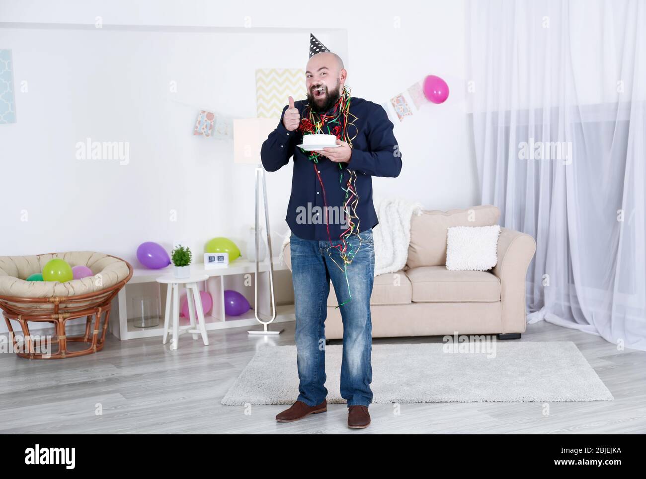 Funny fat man with birthday cake at party Stock Photo - Alamy