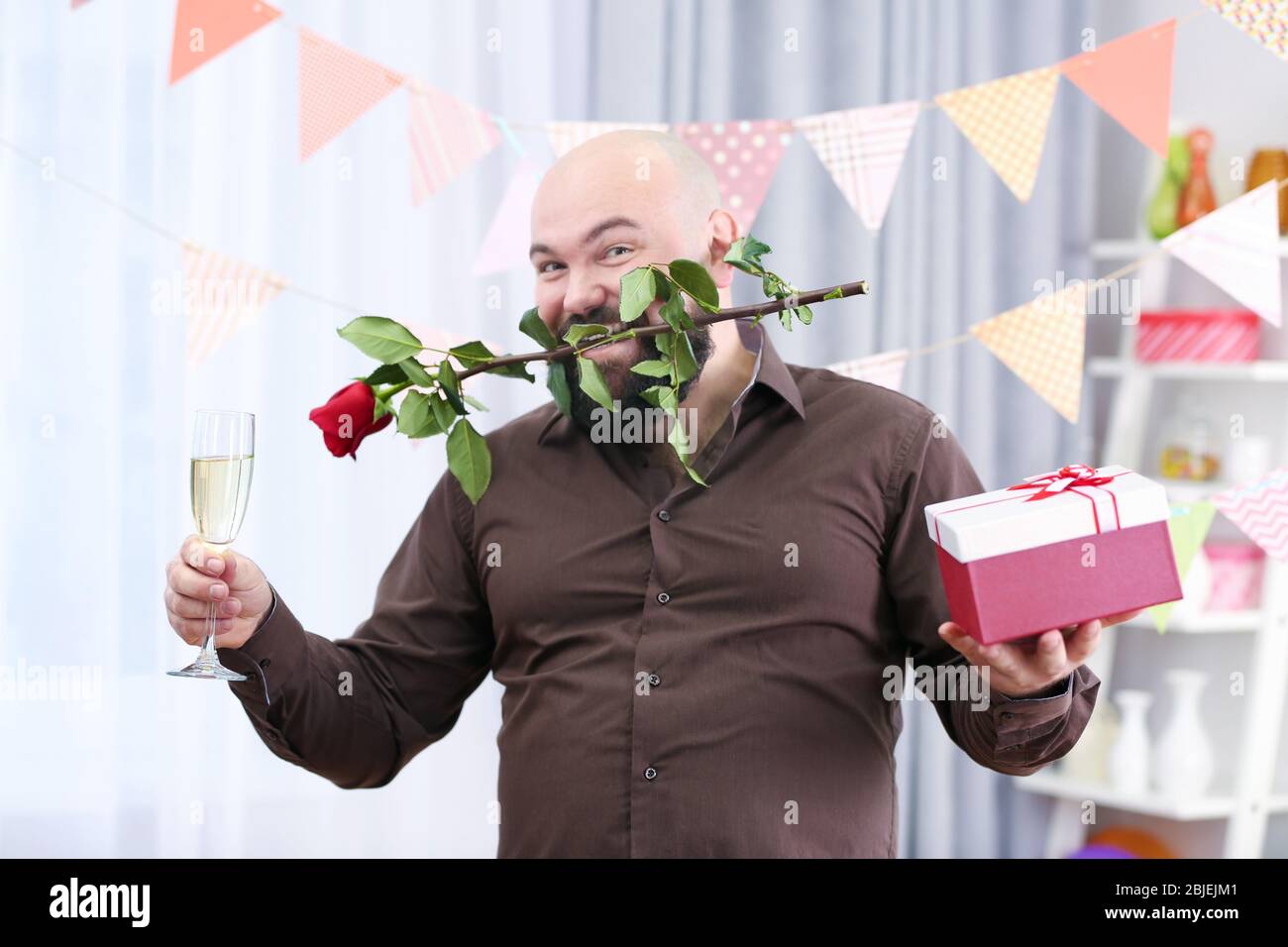 Funny fat man celebrating birthday at home Stock Photo - Alamy