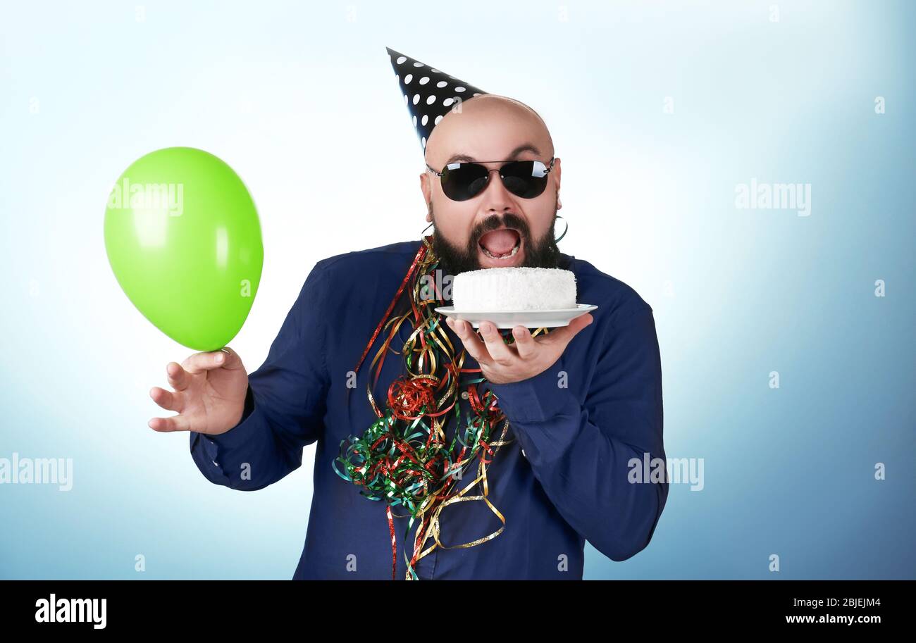 Funny fat man with birthday cake and balloon on color background Stock ...
