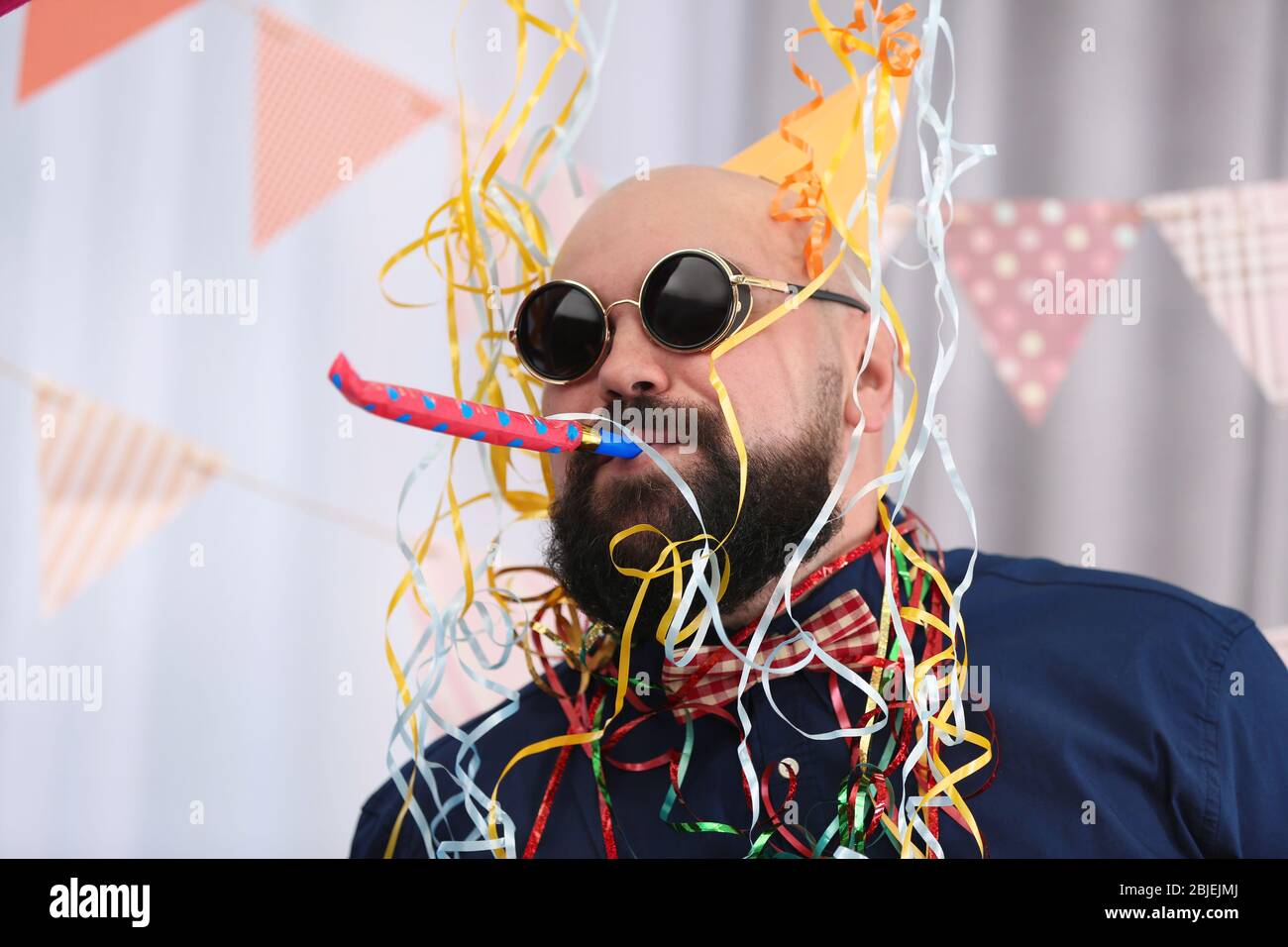 Funny fat man celebrating birthday at home Stock Photo - Alamy