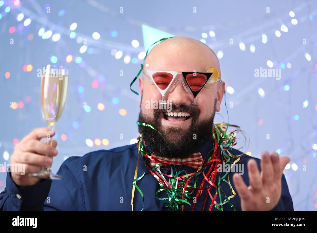 Funny fat man celebrating birthday at party Stock Photo - Alamy