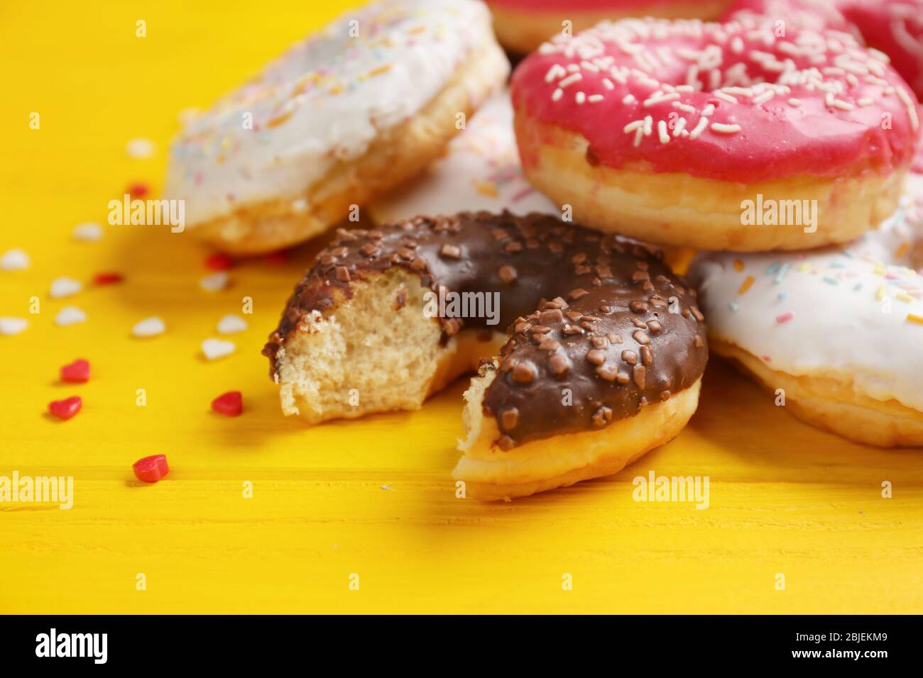 Tasty glazed donuts on color background Stock Photo - Alamy