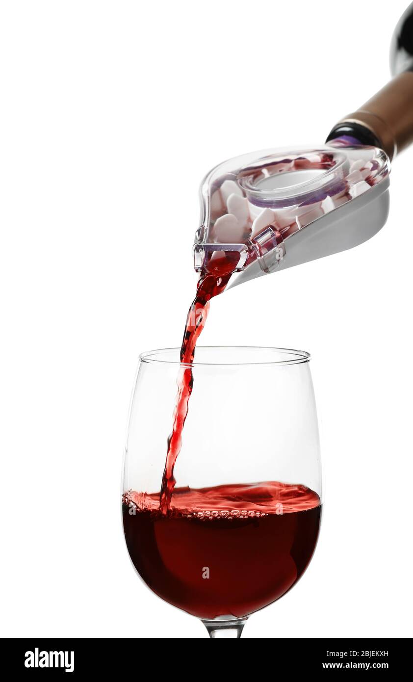 Pouring red wine into glass on white background Stock Photo - Alamy