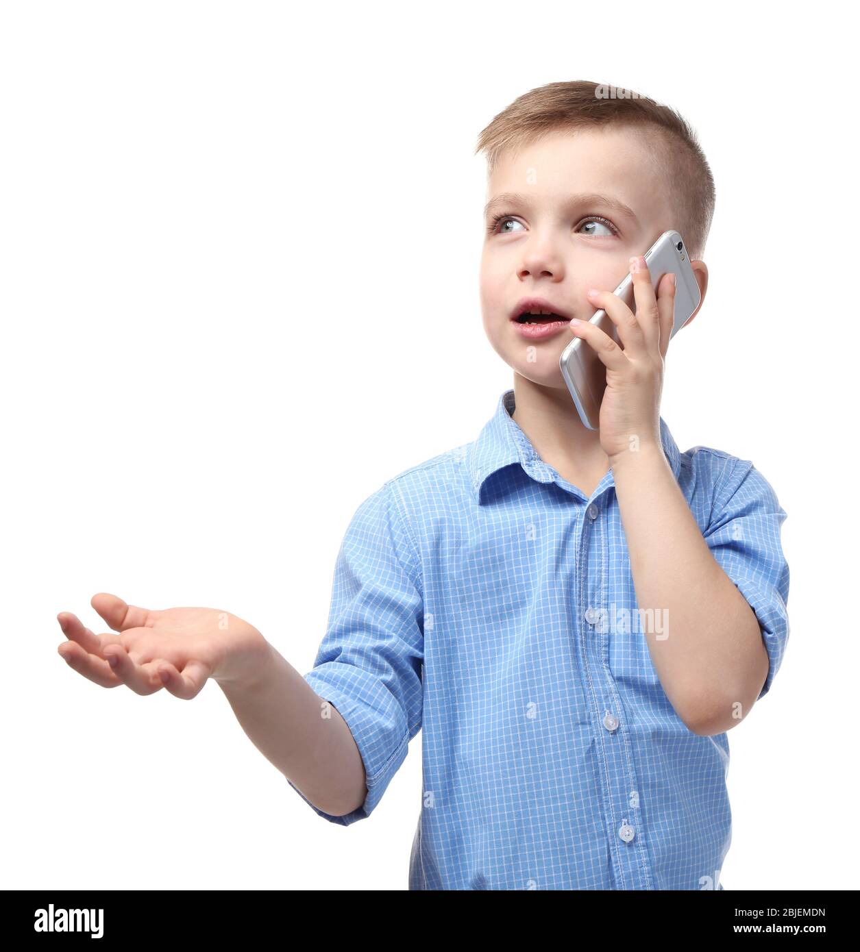Cute little boy talking by mobile phone on white background Stock Photo ...