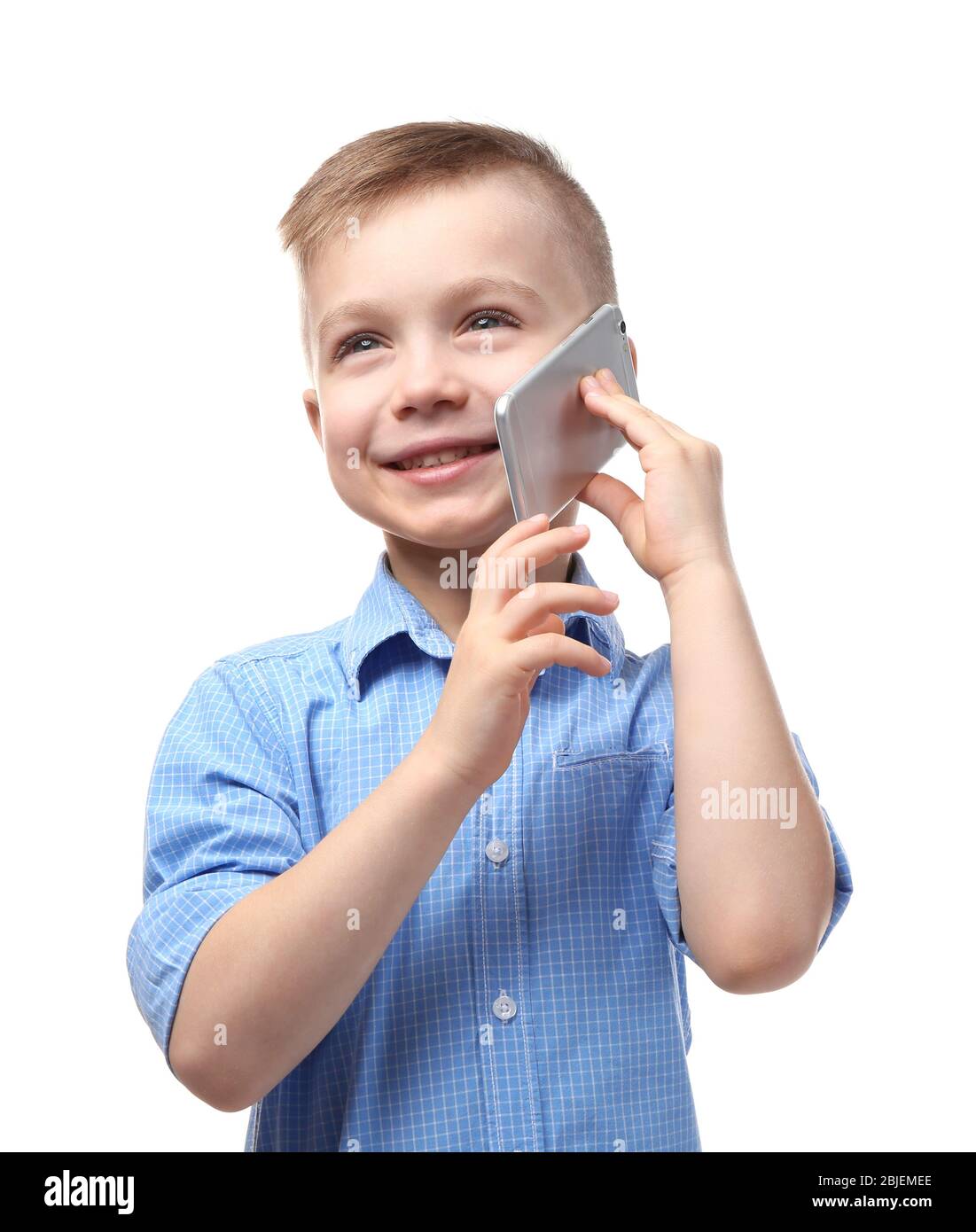 Cute little boy talking by mobile phone on white background Stock Photo ...