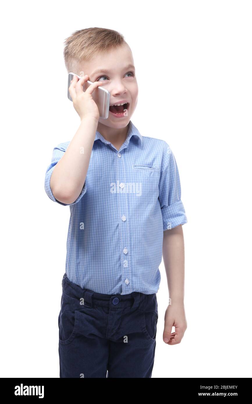Cute little boy talking by mobile phone on white background Stock Photo ...