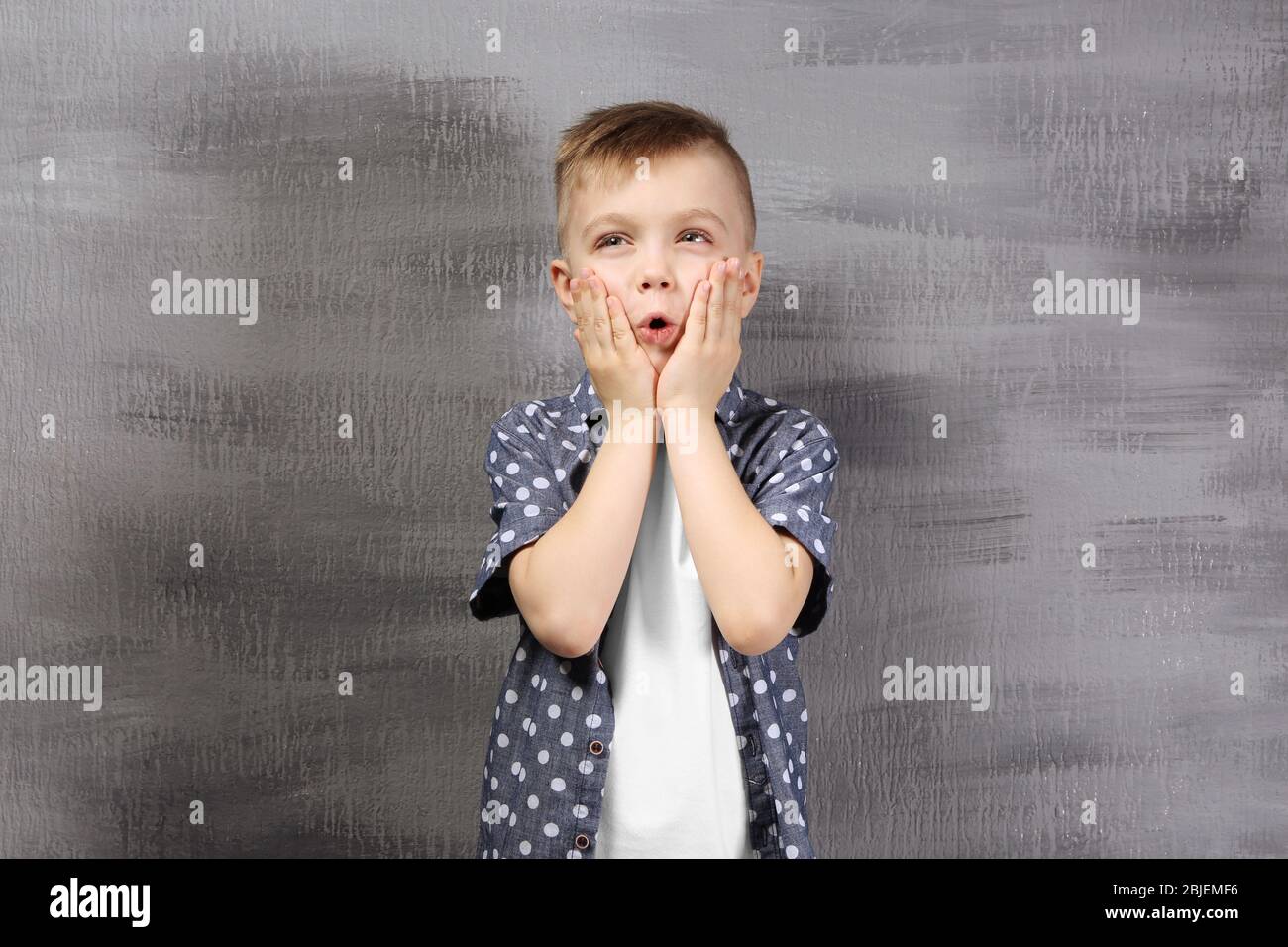 Cute little boy on color background Stock Photo - Alamy