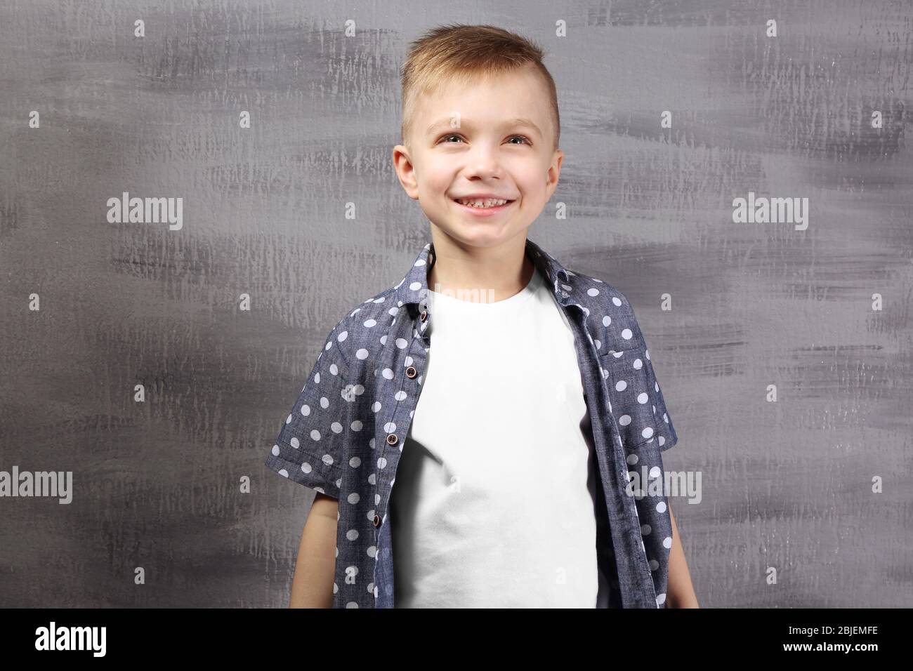 Cute little boy on color background Stock Photo - Alamy