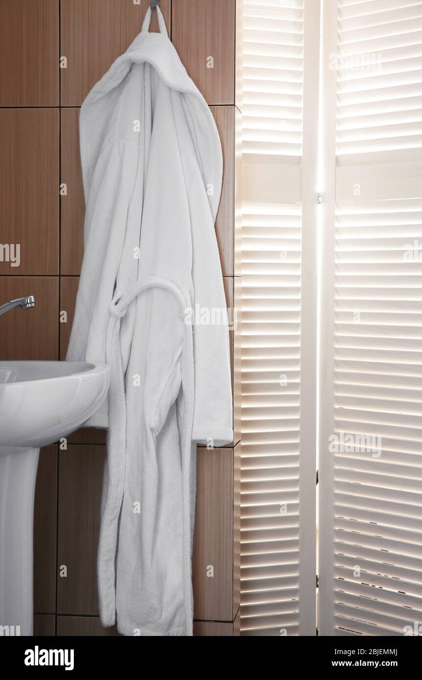Bathrobe hanging on hook at spa salon Stock Photo - Alamy