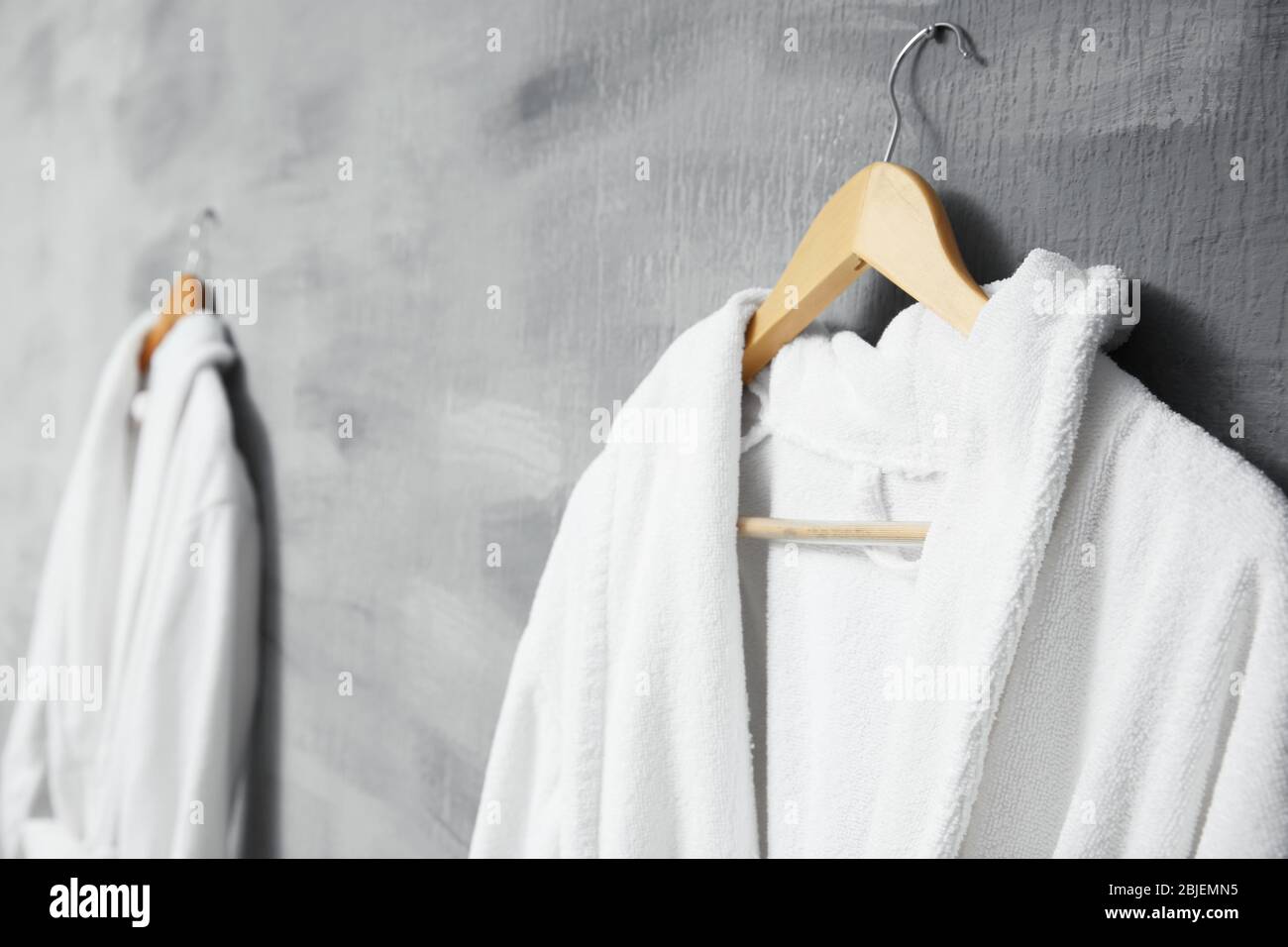 Bathrobe hanging on wall at spa salon Stock Photo - Alamy