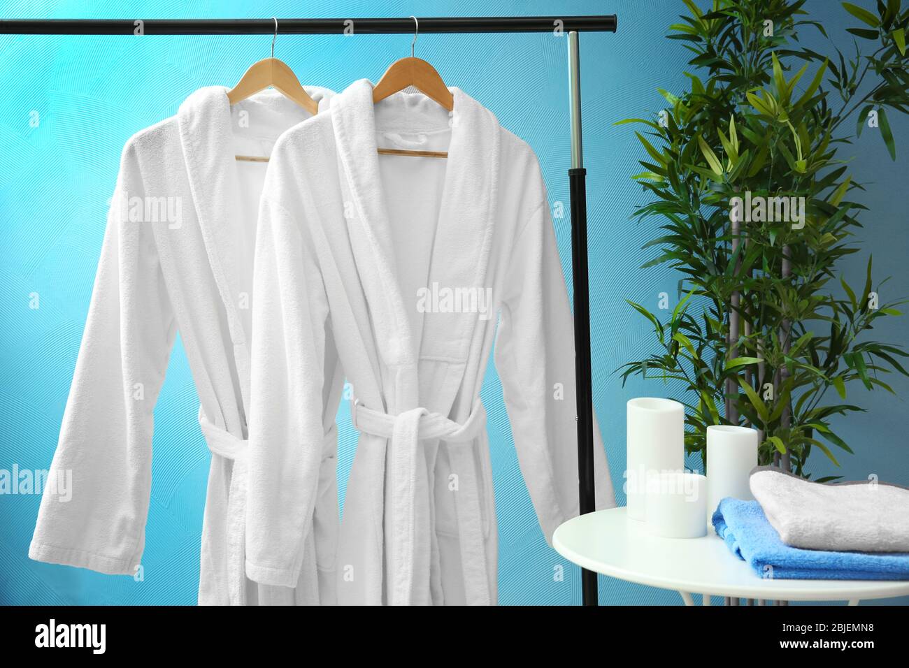 Bathrobes hanging on rack at spa salon Stock Photo - Alamy