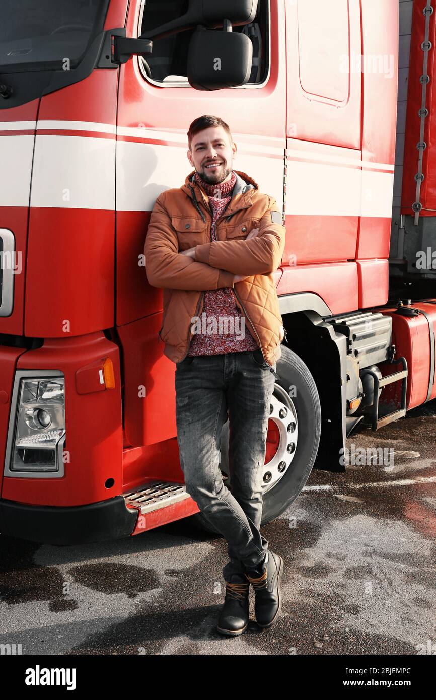 Handsome driver near big modern truck outdoors Stock Photo - Alamy