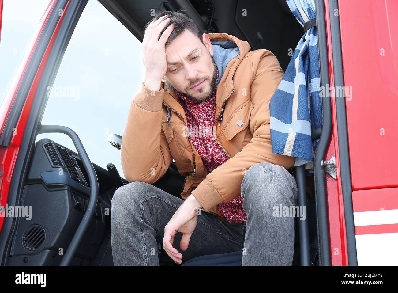 Driver in cabin of big modern truck Stock Photo - Alamy