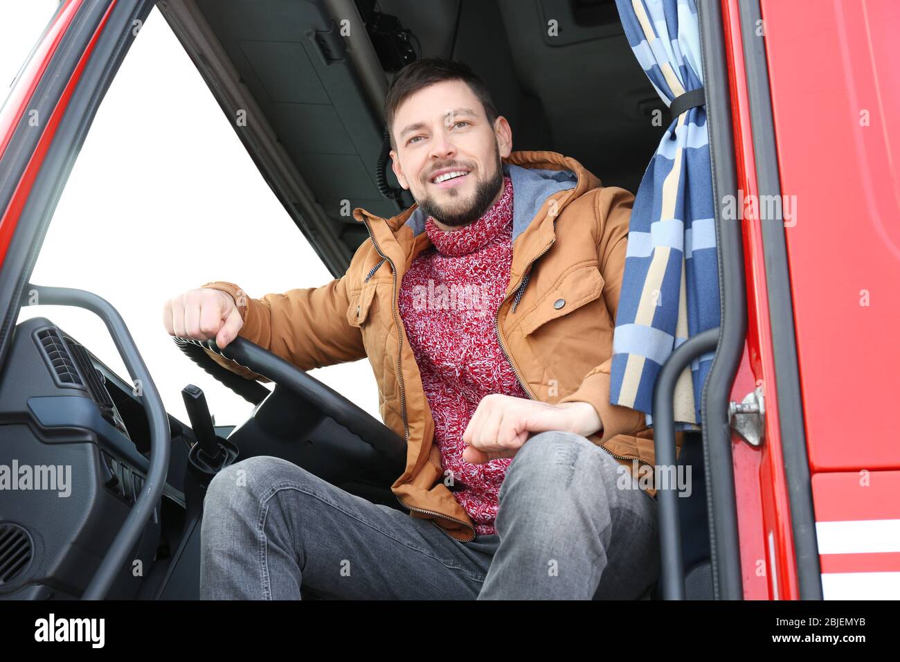 Driver in cabin of big modern truck Stock Photo - Alamy