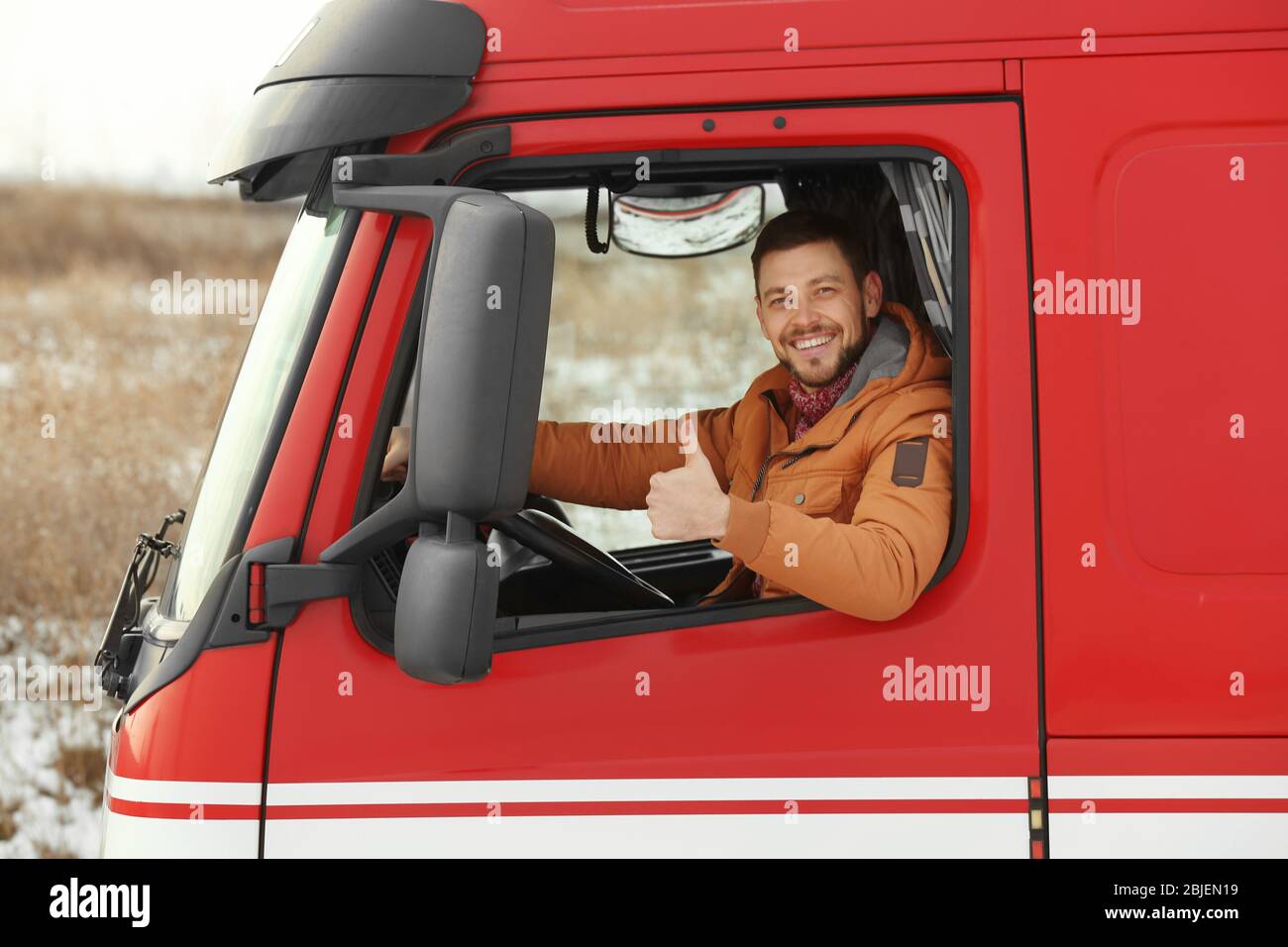 Young man driving big modern truck Stock Photo - Alamy