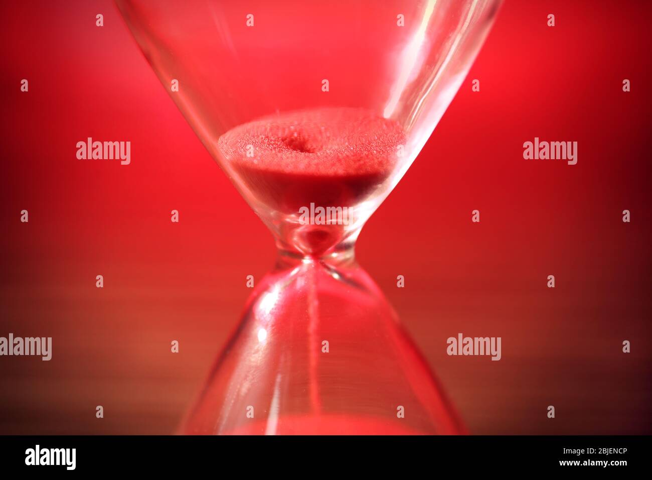 Hourglass red flowing sand hi-res stock photography and images - Alamy