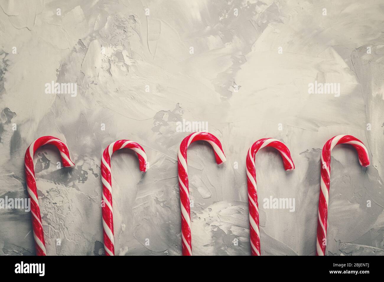 Christmas candies in a row on colour textured background Stock Photo ...