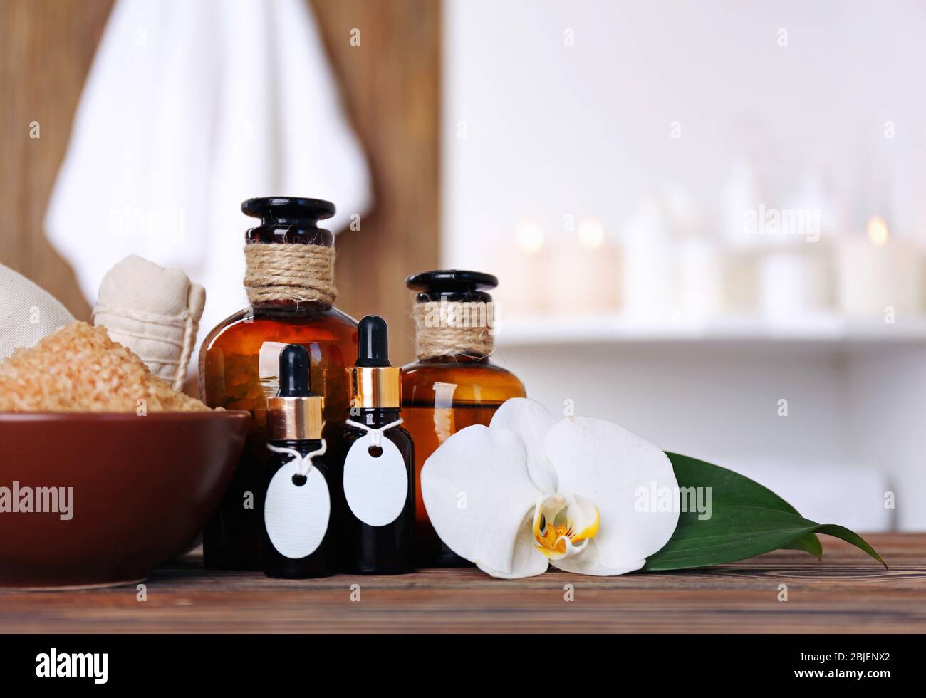 Spa set with aroma oils on wooden table Stock Photo - Alamy