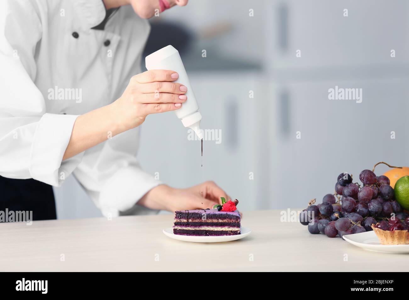 Female chef finishing dessert hi-res stock photography and images - Alamy