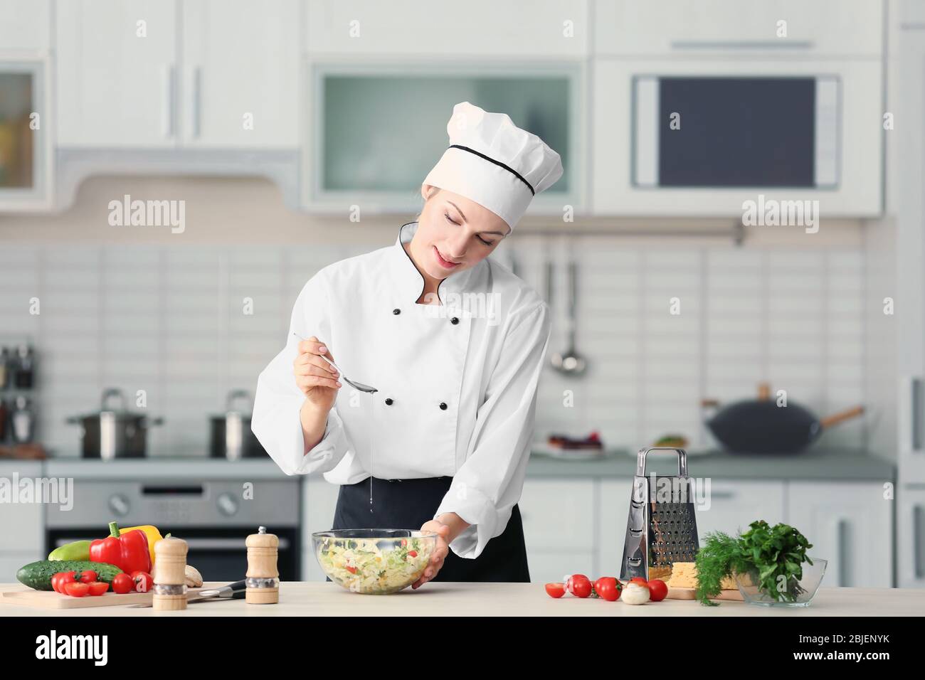 Professional kitchen chef adding oil hi-res stock photography and ...