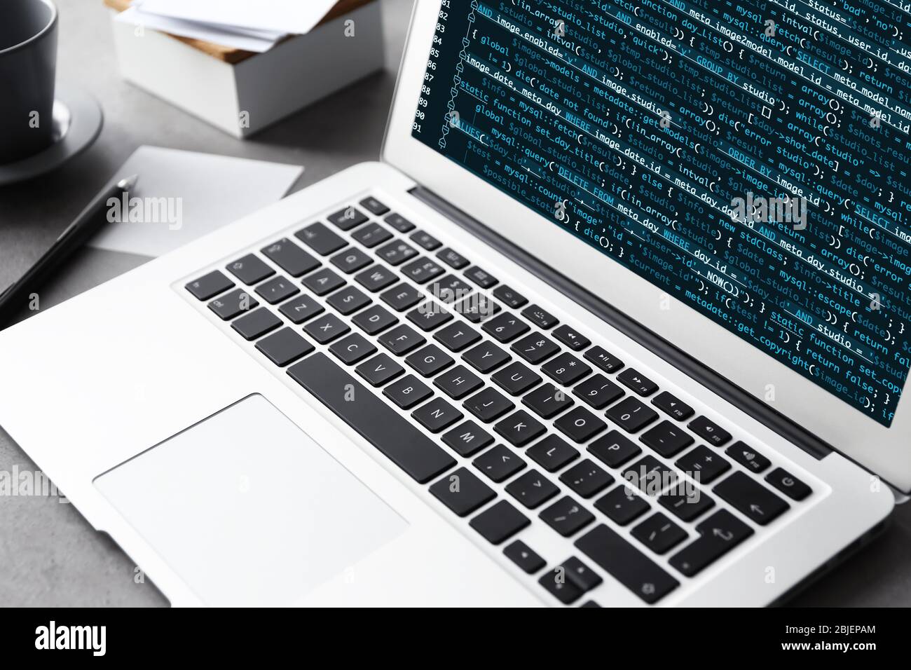 Laptop of programmer with script code on display Stock Photo - Alamy