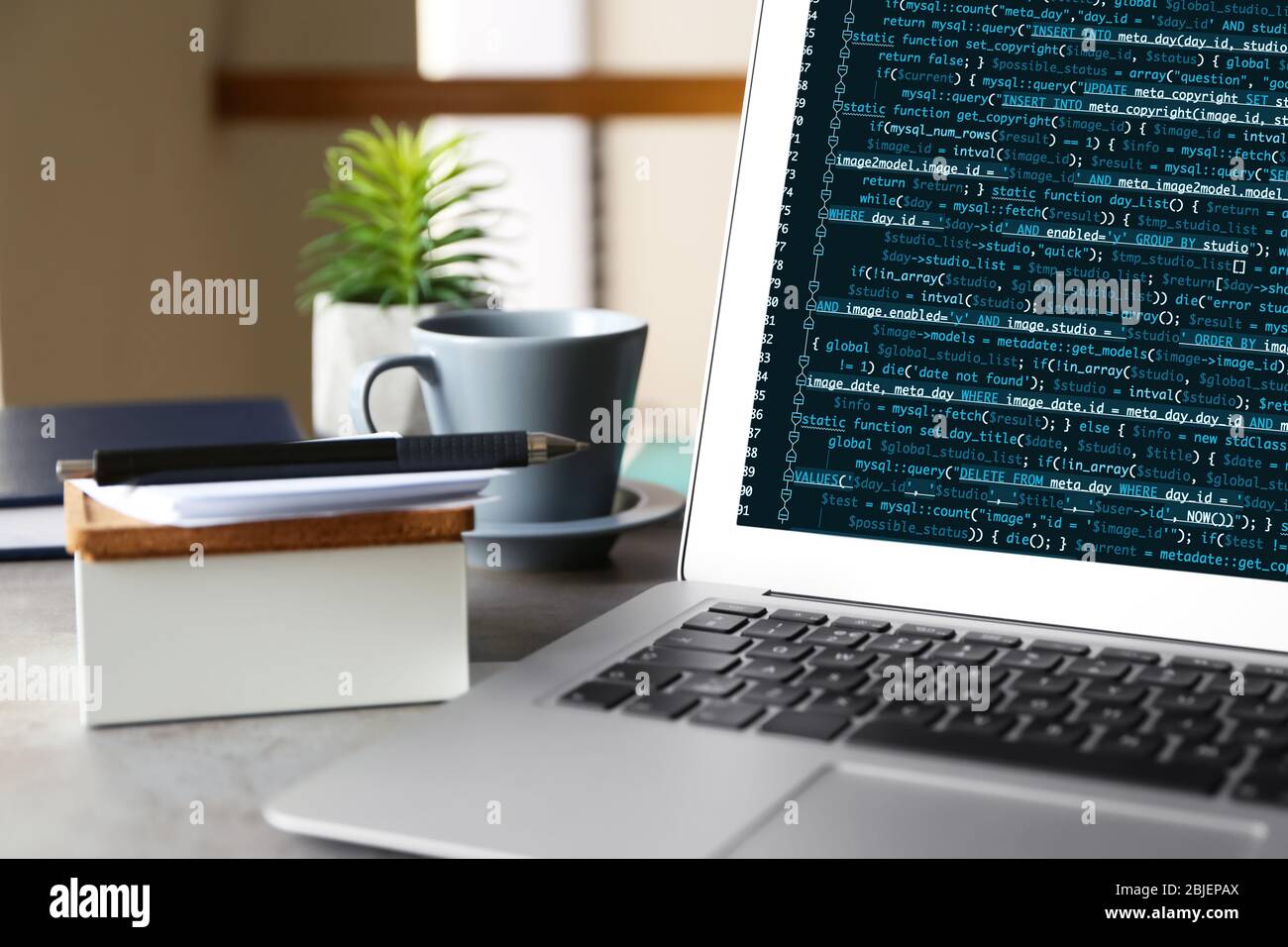 Laptop of programmer with script code on display Stock Photo - Alamy