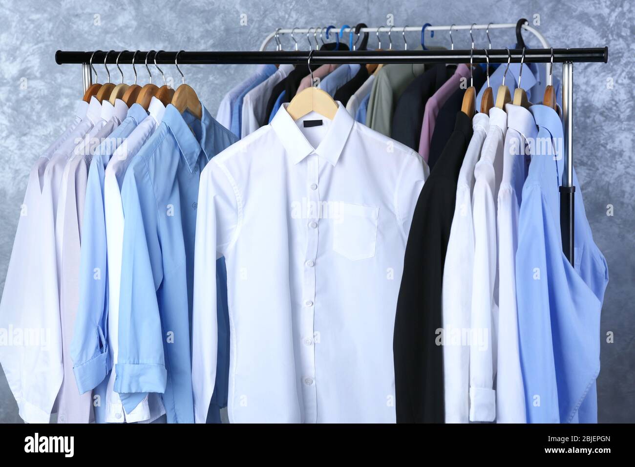 Rack of clean clothes hanging on hangers at dry-cleaning Stock Photo ...
