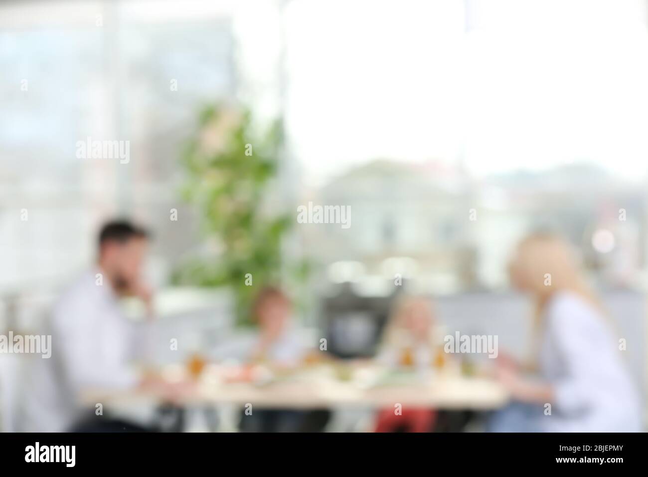 Blurred view of family breakfast Stock Photo - Alamy
