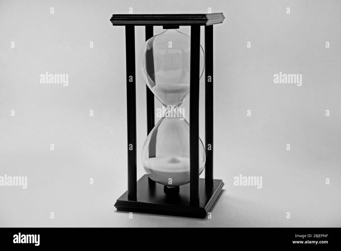 Hourglass on light background Stock Photo - Alamy