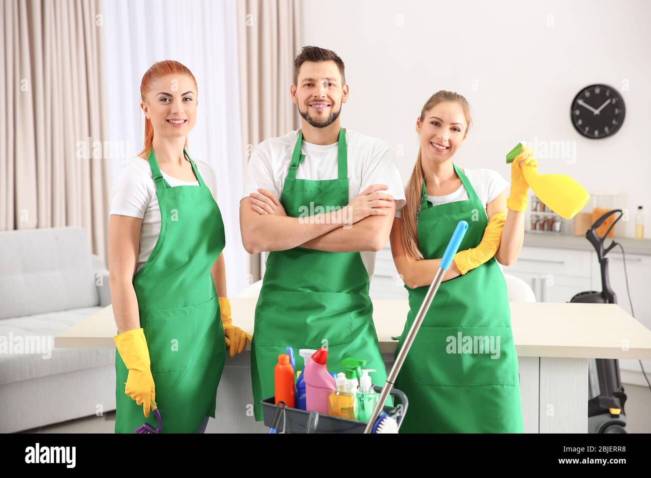 Cleaning service team at work in kitchen Stock Photo - Alamy