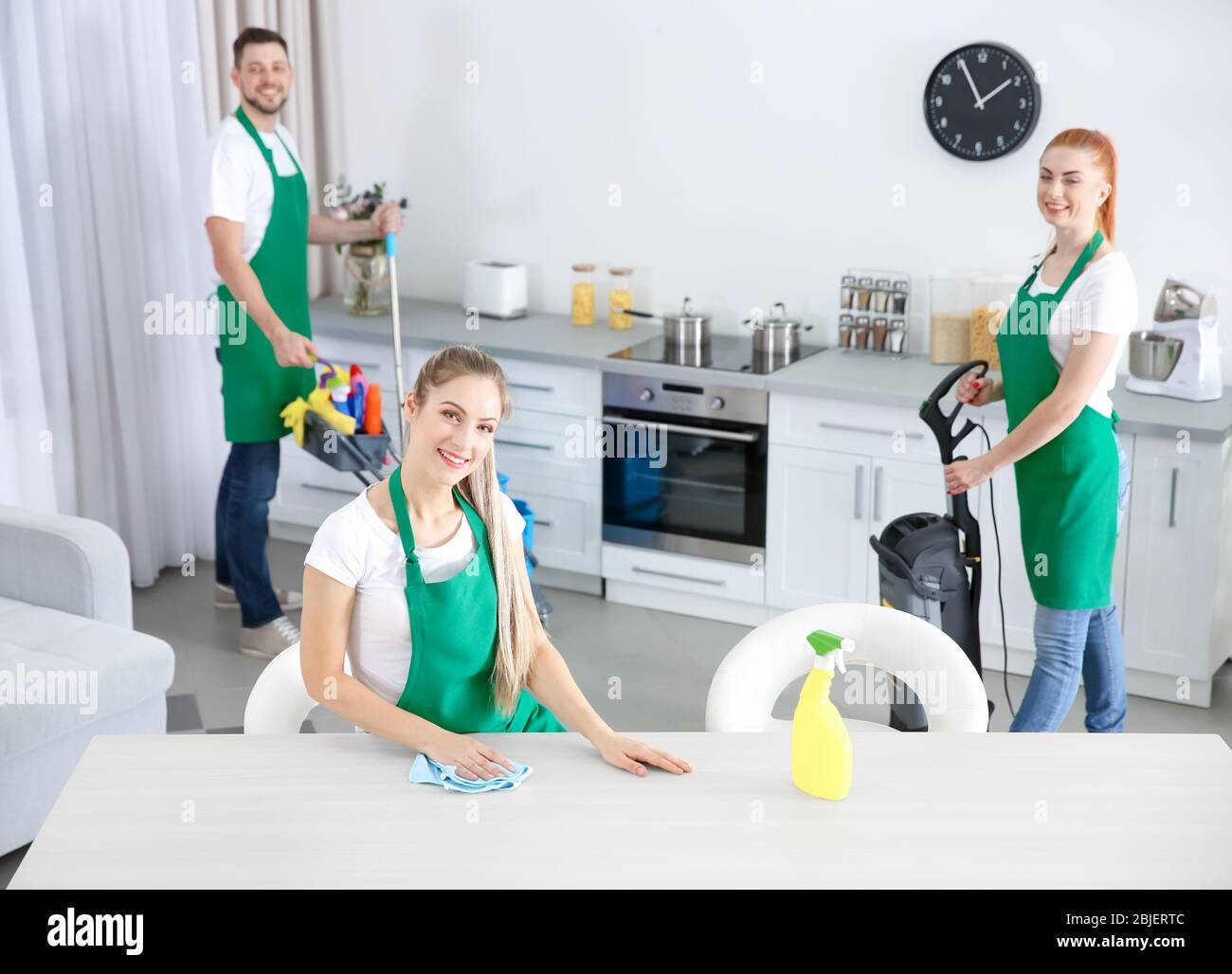 Cleaning service team working in kitchen Stock Photo - Alamy