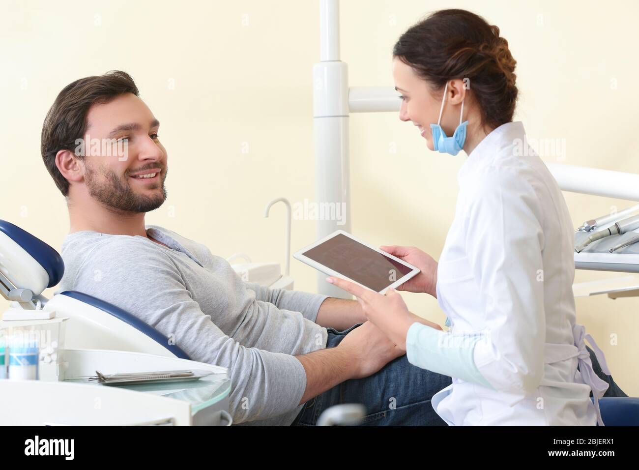 Man visiting female dentist at clinic Stock Photo - Alamy