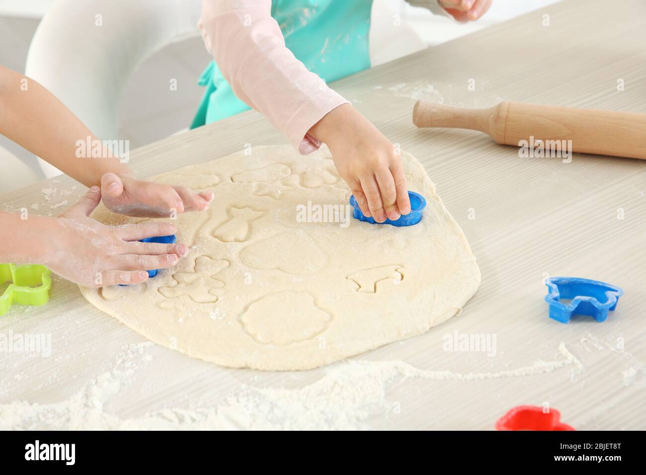 Little kids making biscuits on table Stock Photo - Alamy