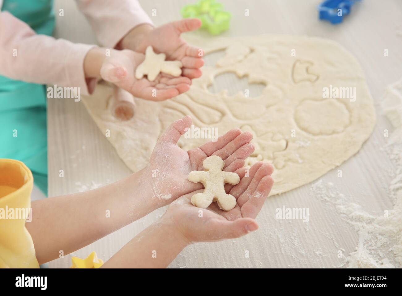Little kids making biscuits on table Stock Photo - Alamy
