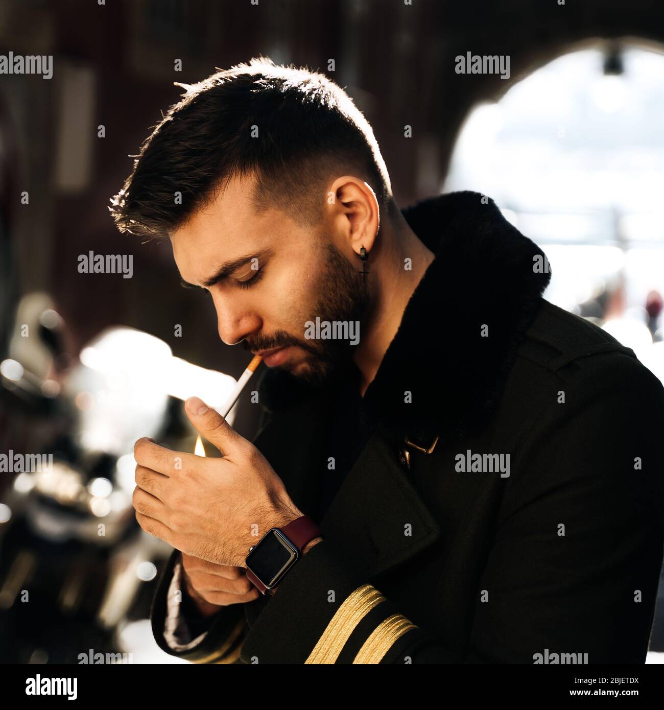 Young man lighting cigar hi-res stock photography and images - Alamy