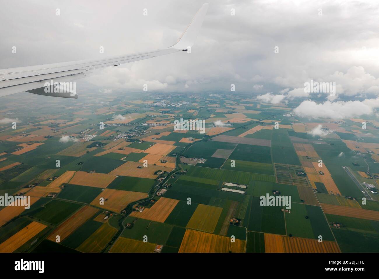 Airplane shot out the window with beautiful fields and cloudy sky Stock ...