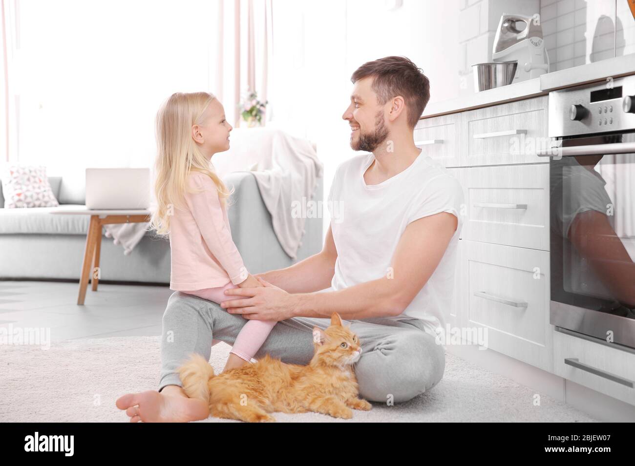 Father and his daughter with cat at home Stock Photo - Alamy