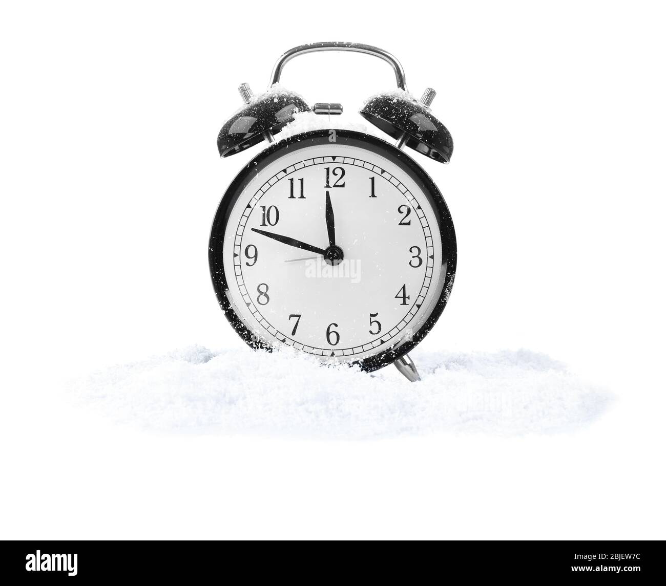 Alarm clock with snow isolated on white Stock Photo - Alamy
