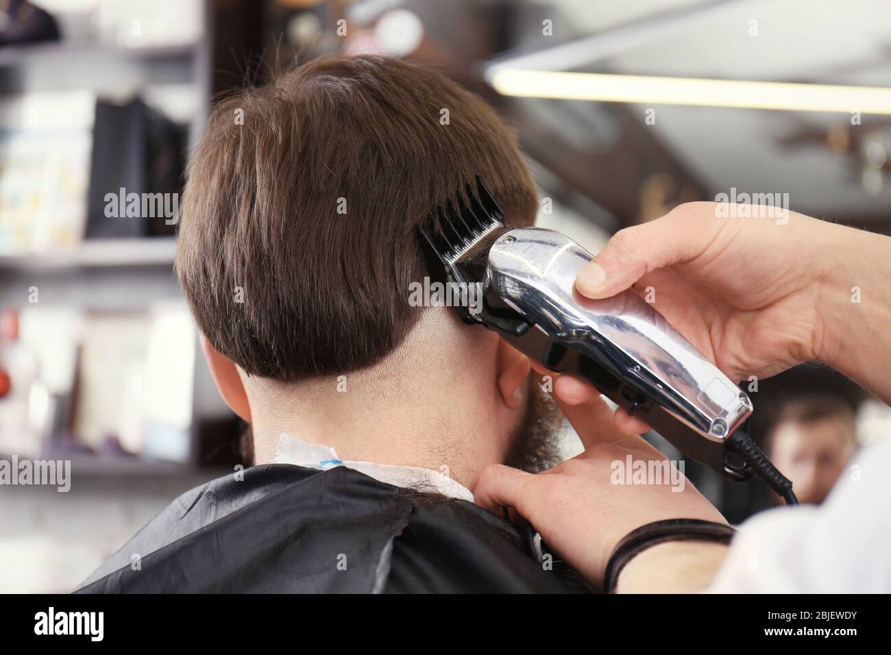 Barber making hairstyle confident hi-res stock photography and images ...