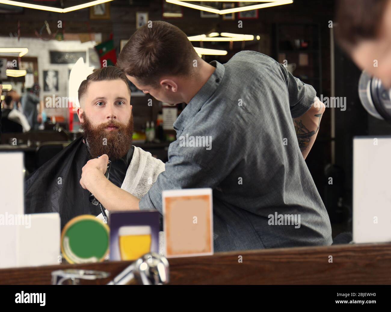 Hairdresser shaving client in barbershop Stock Photo - Alamy